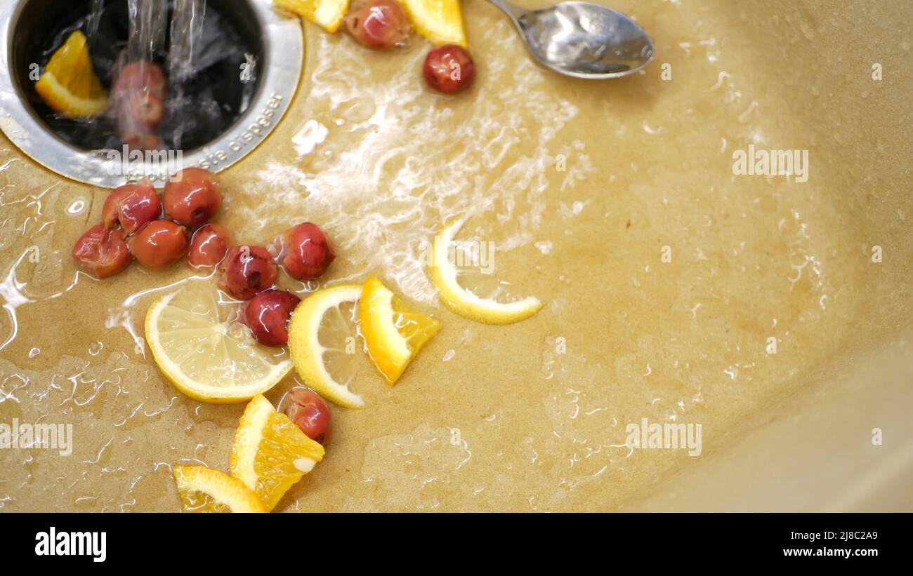 Organic garbage in sink with built-in food waste disposer. vegetable or ...
