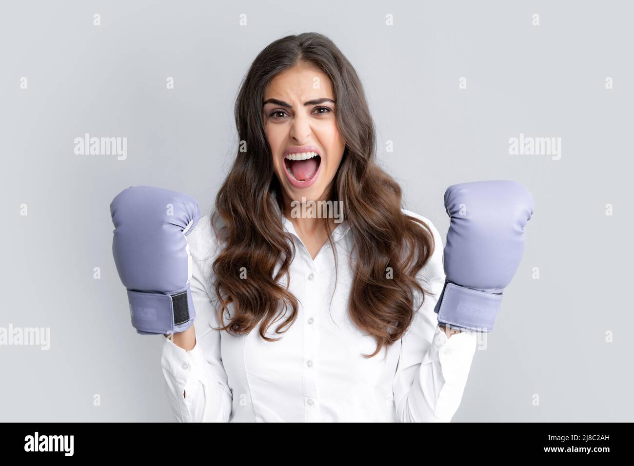 Angry woman in boxing gloves. Successful businesswoman has boxing ...