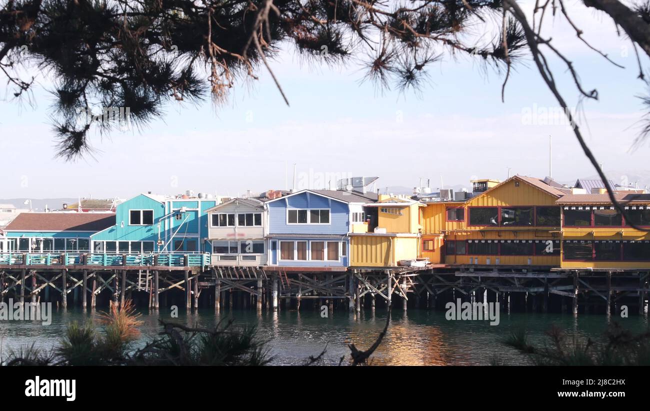 Colorful wooden houses on piles, pillars or pylons, ocean sea water ...