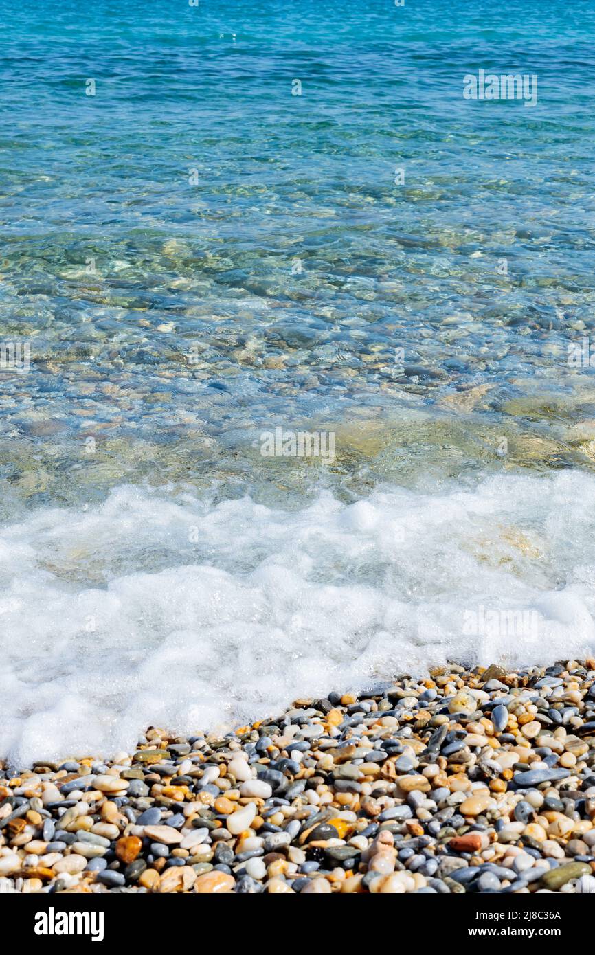 Sea waves on the coast. Transparent sea water and pebbles. Seaside ...