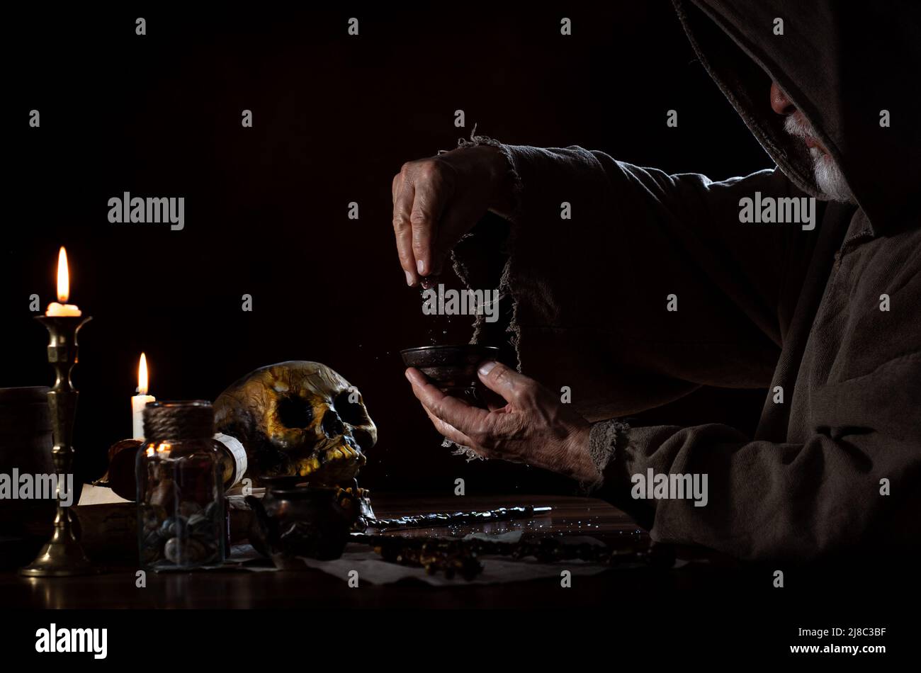 A medieval wizard mixes elixir Stock Photo - Alamy