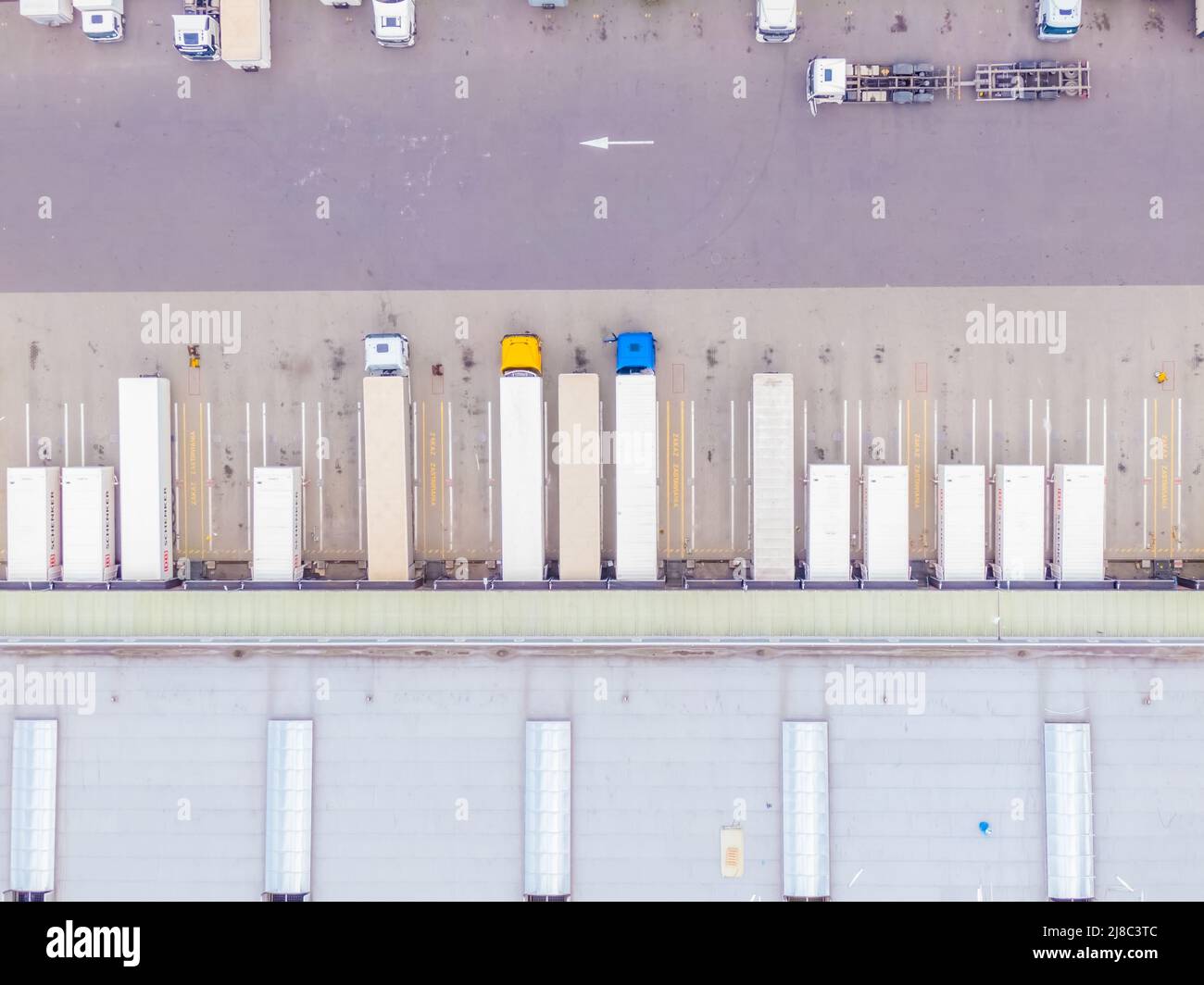 Aerial view of colorful trucks in the terminal waiting for unloading ...