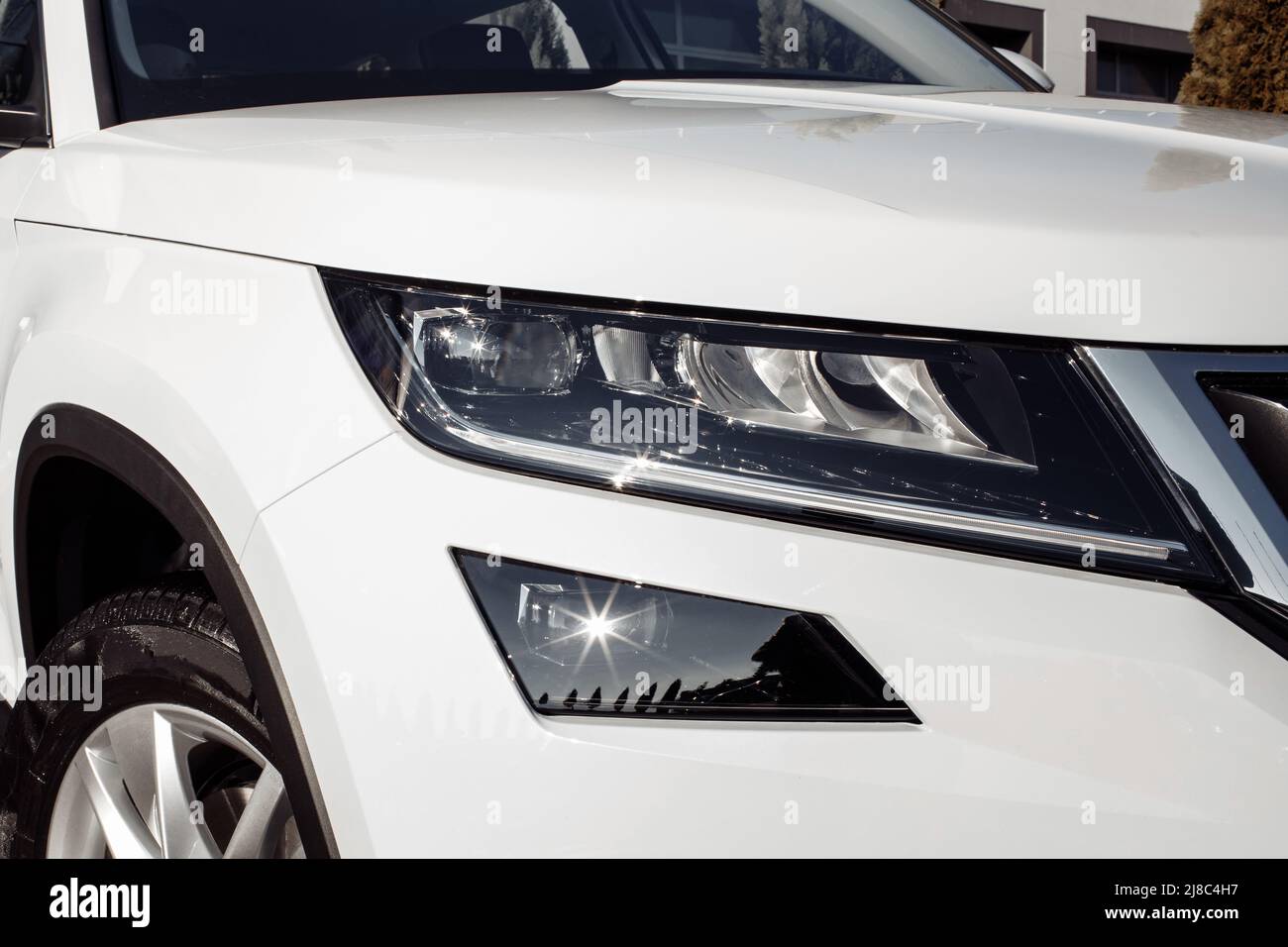 Macro view of modern white car xenon lamp headlight, bumper. Exterior ... Macro view of modern white car xenon lamp headlight, bumper. Exterior ...