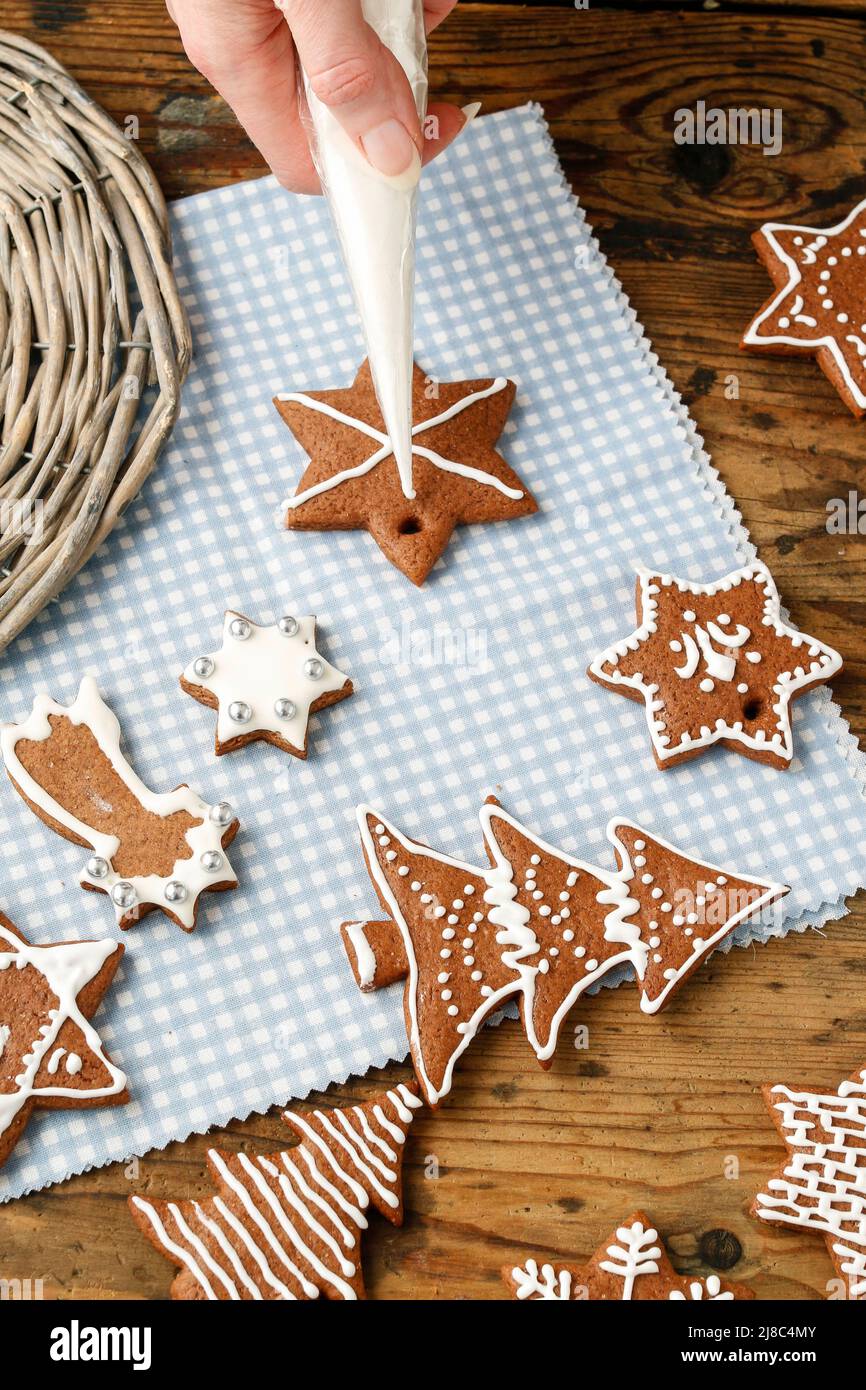 Decorating gingerbread cookies for christmas. Steps of making biscuits ...