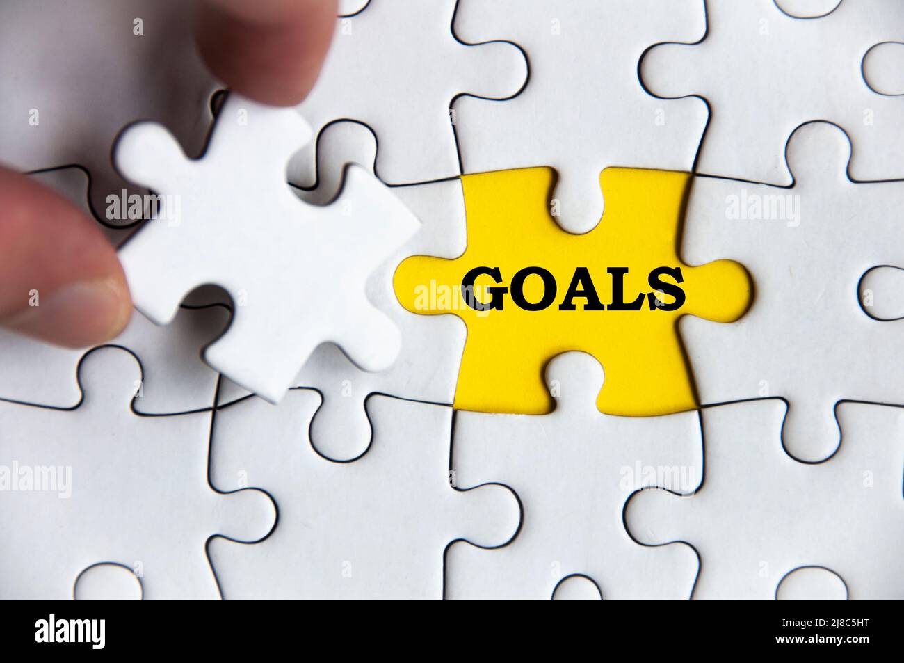 Goals text on missing jigsaw puzzle. Goal setting concept Stock Photo ...