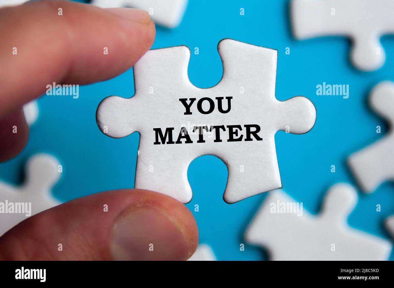 Motivational text on jigsaw puzzle with blue background - You matter ...