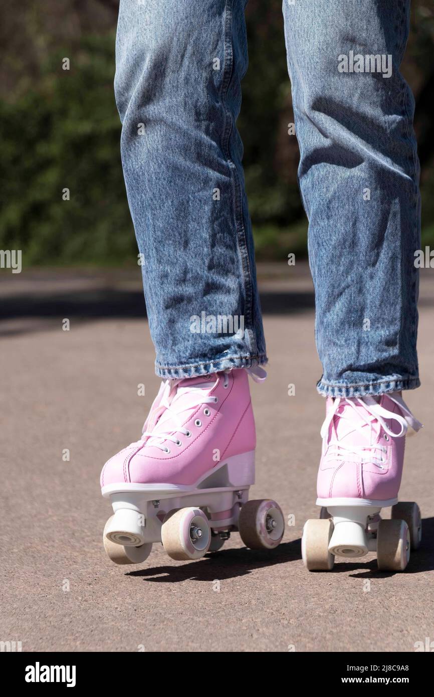 woman skating in jeans and pink roller skates Stock Photo - Alamy