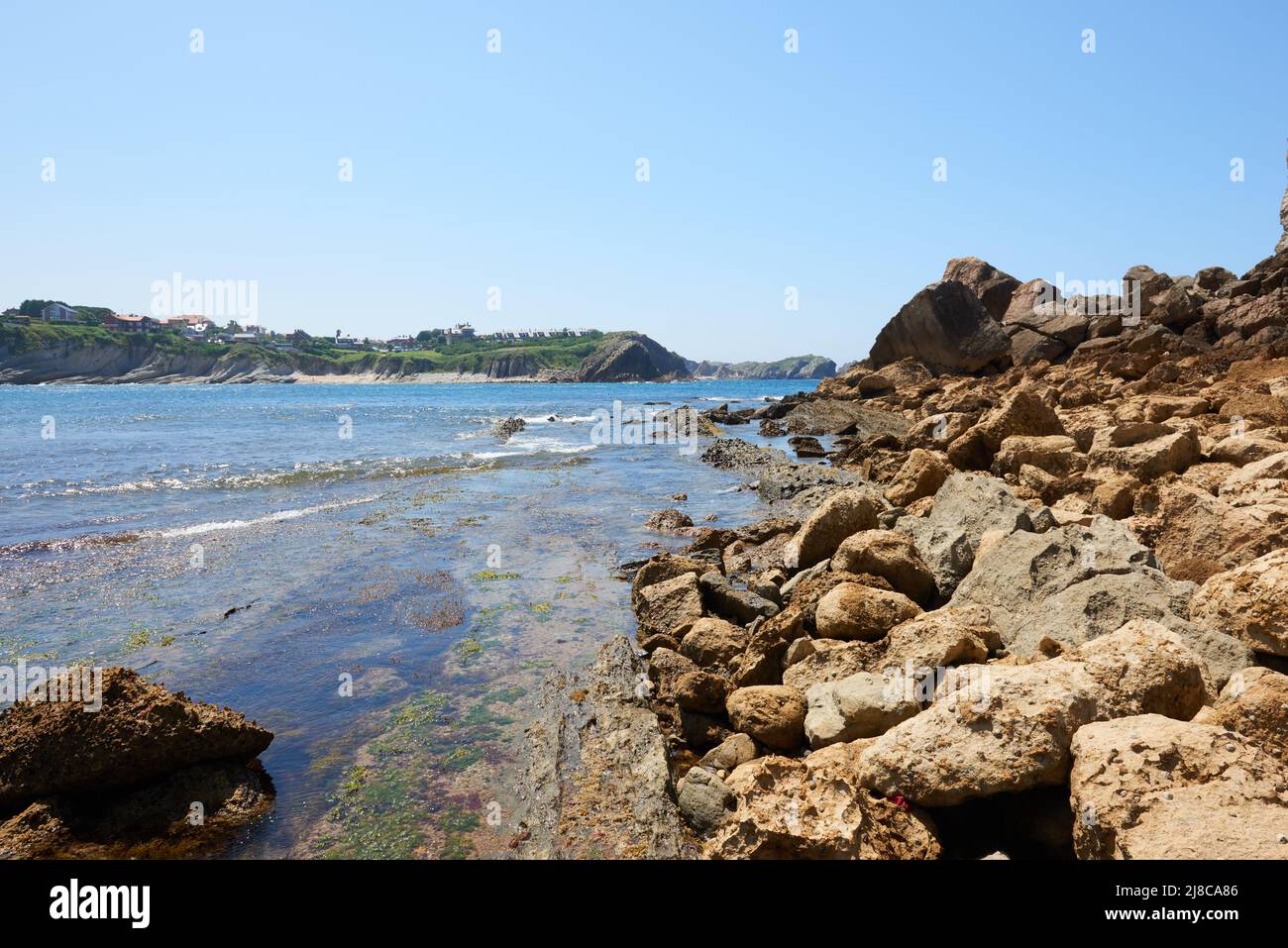Steep cliffs with a deep blue sea and a clear blue sky Stock Photo - Alamy
