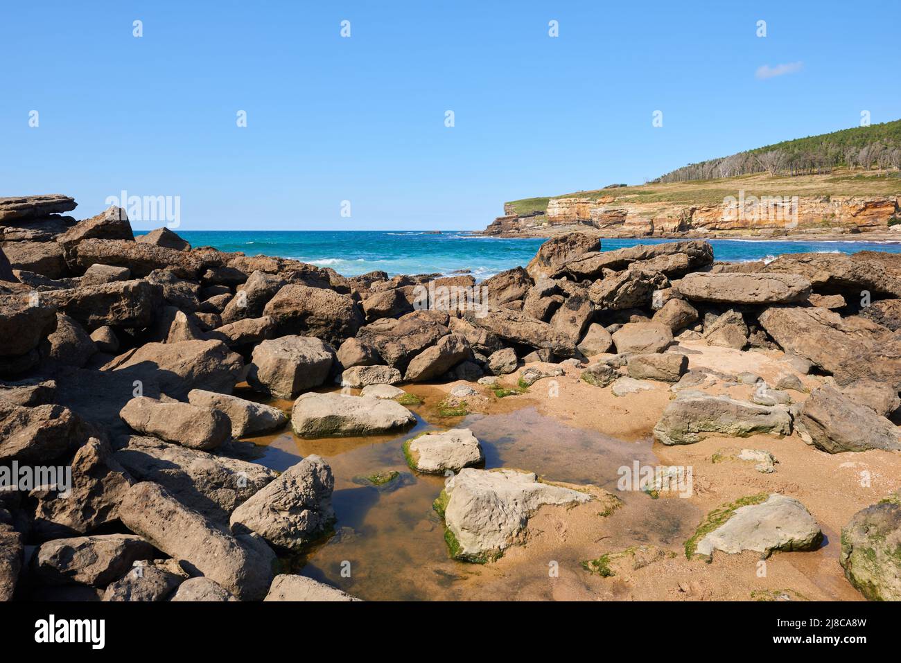 Steep cliffs with a deep blue sea and a clear blue sky Stock Photo - Alamy