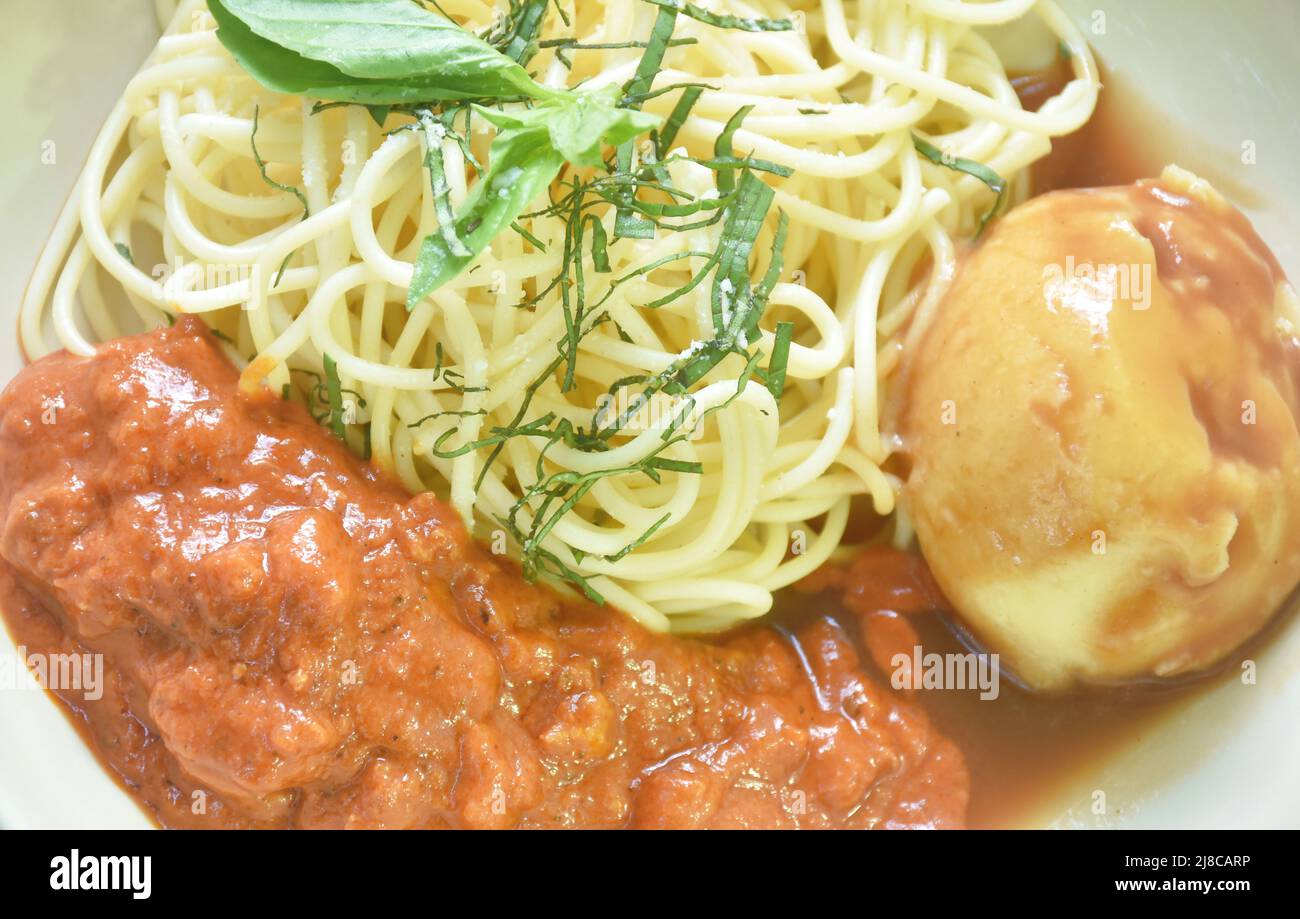 spaghetti topping basil leaf dressing fried chop pork and slice tomato ...