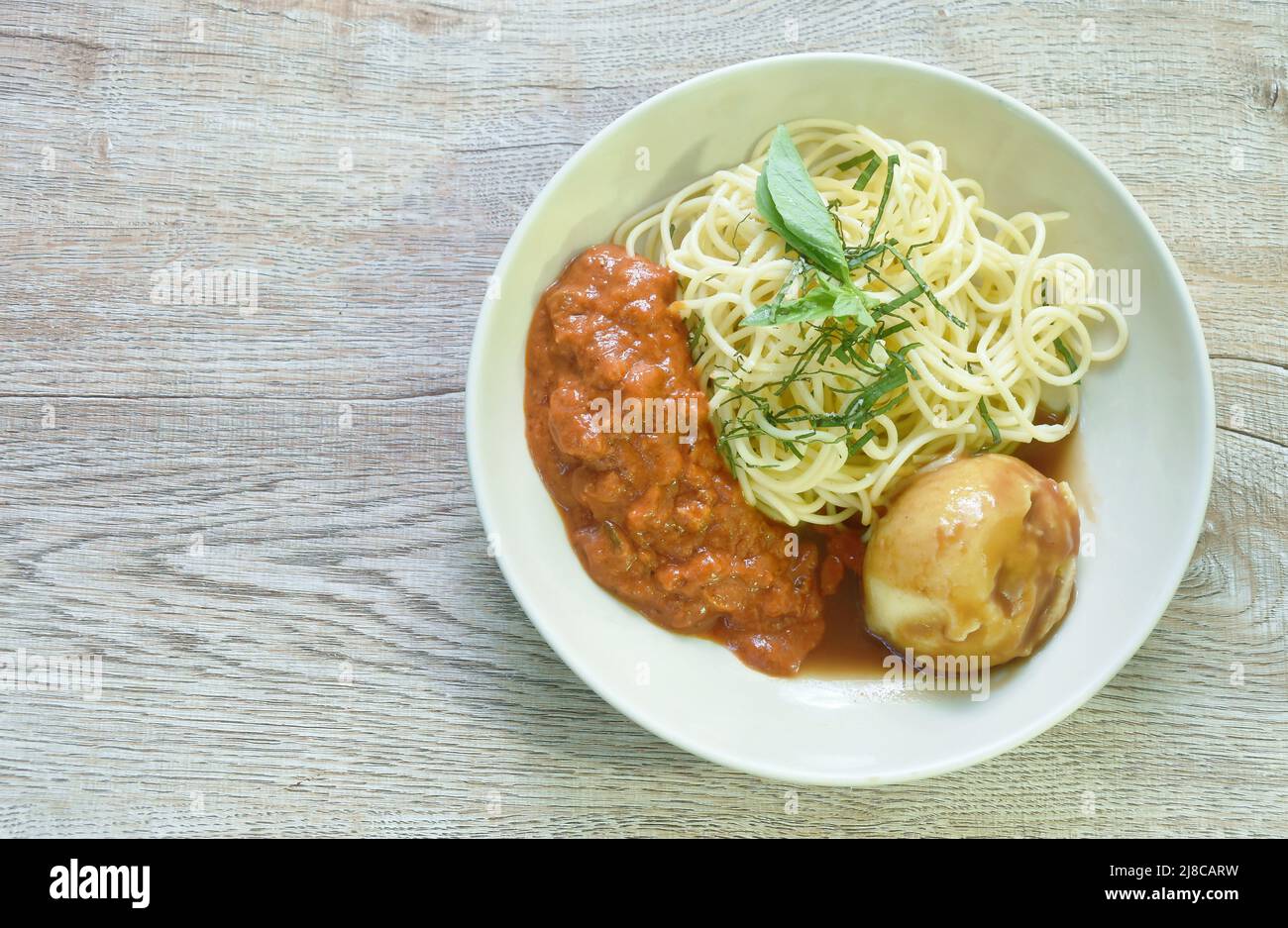 spaghetti topping basil leaf dressing fried chop pork and slice tomato ...