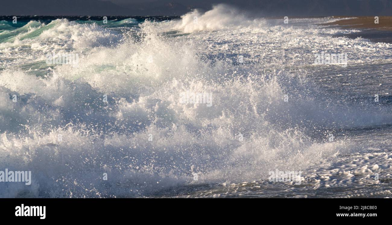 Sea wave hitting the beach Stock Photo - Alamy
