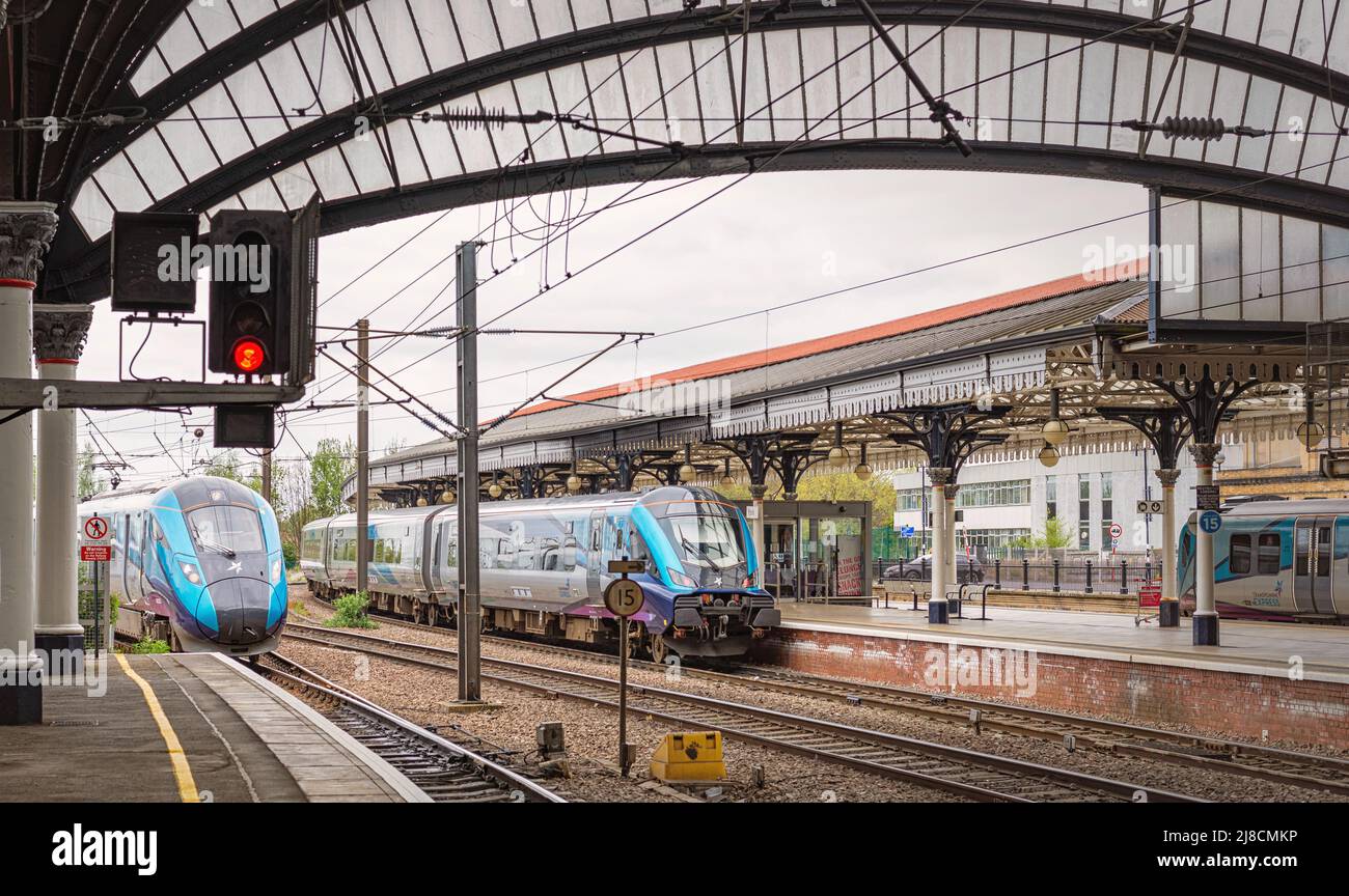 A locomotive approaches a railway station entrance and two others are ...