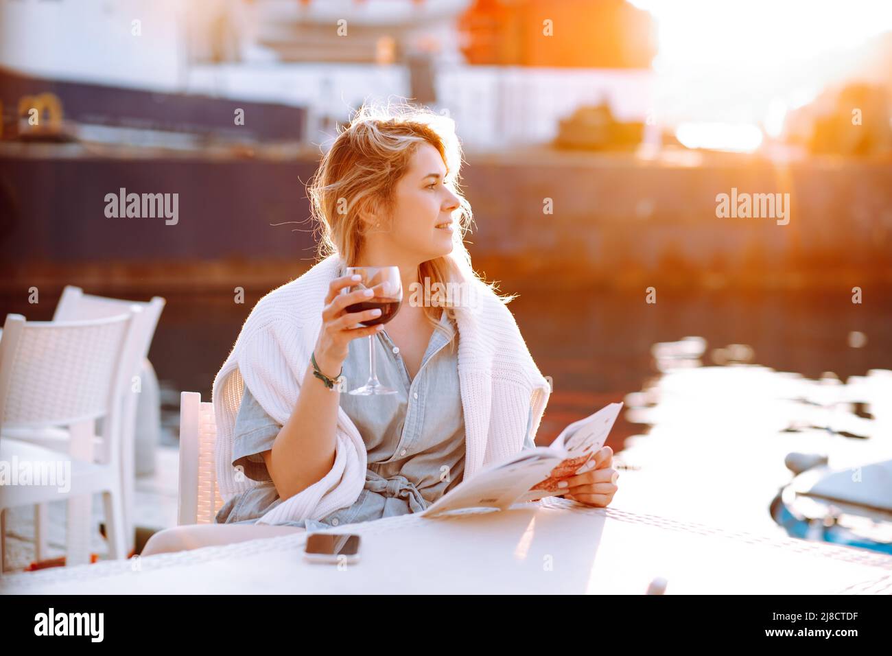 Woman sitting alone at table hi-res stock photography and images - Alamy