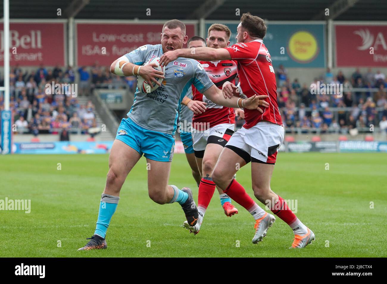 Cameron Smith (17) of Leeds Rhinos is tackled by Ryan Brierley #1 of ...