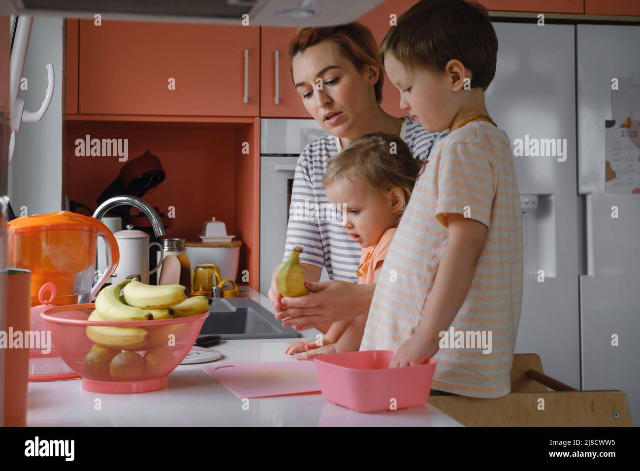 Happy family with kids cooking on modern kitchen. Children cutting ...