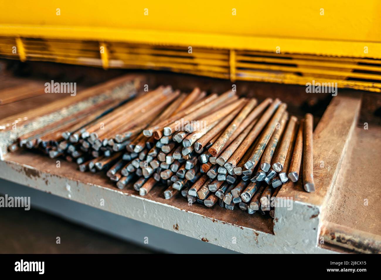 Pins made of metal reinforcement lie in workshop on workbench ...