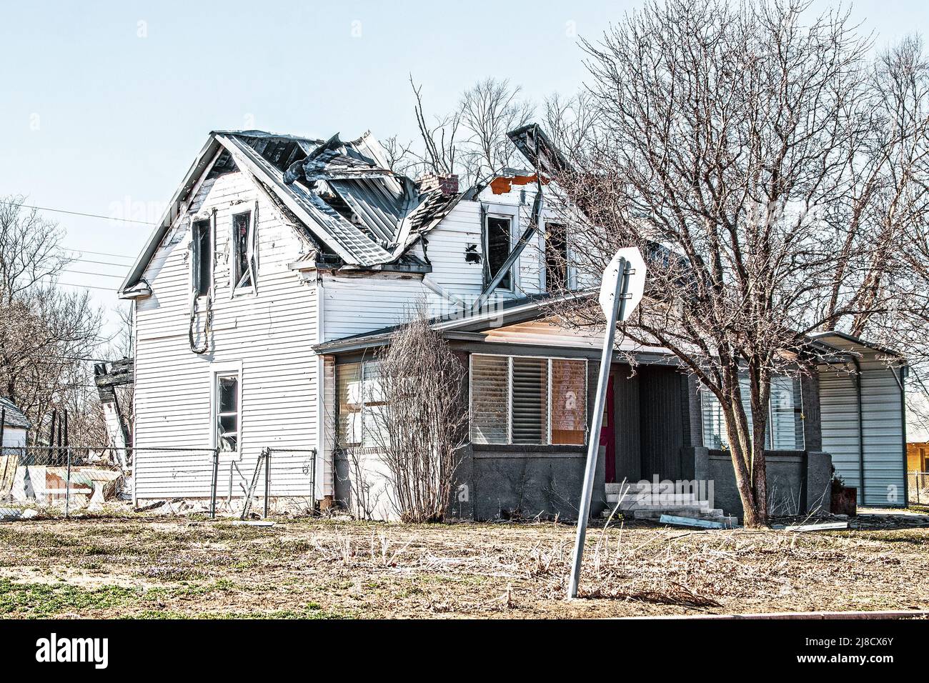 Two story frame house that has been hit by a tornado with roof caved in ...