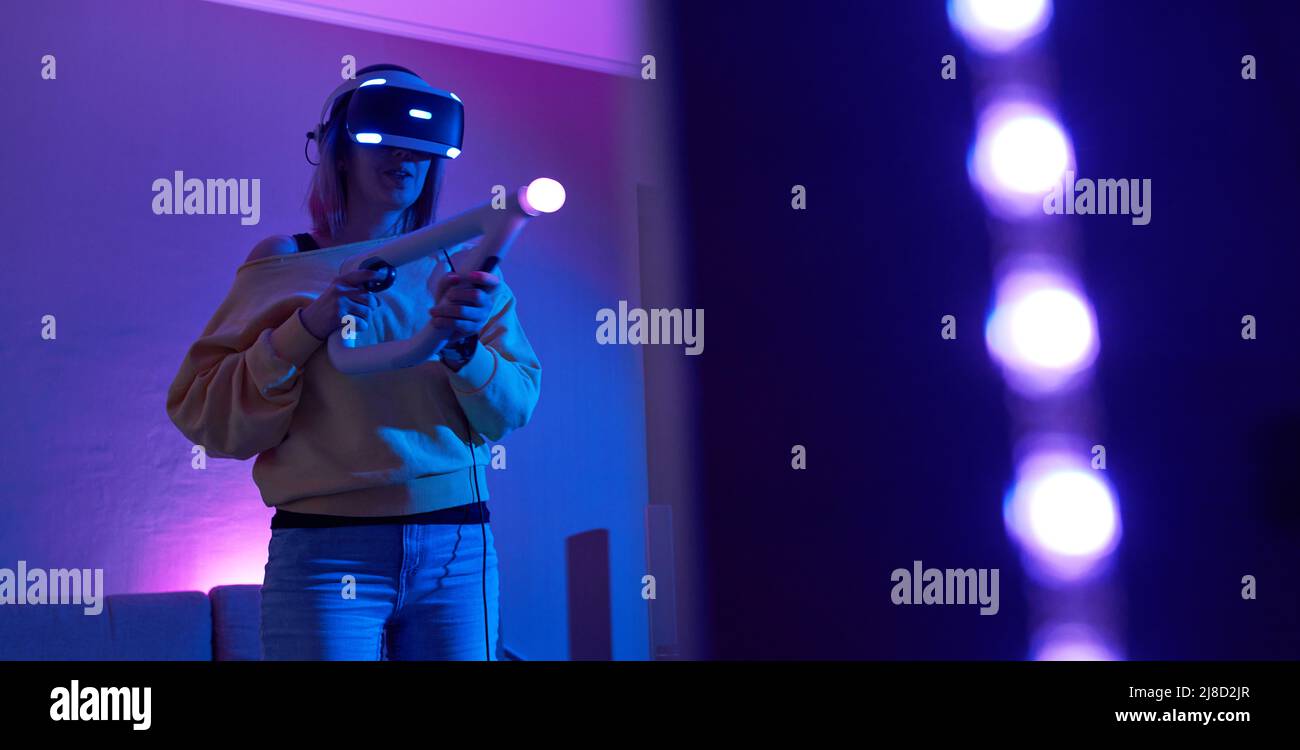 Woman with virtual reality headset are playing game and fighting ...