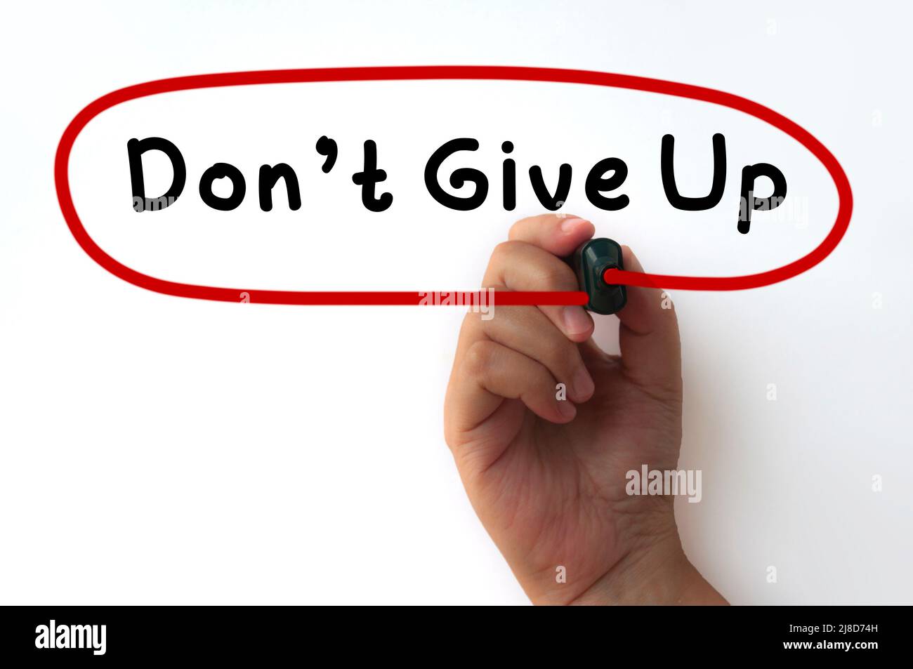 Hand writing circling Don't give up text on transparent wipe board ...