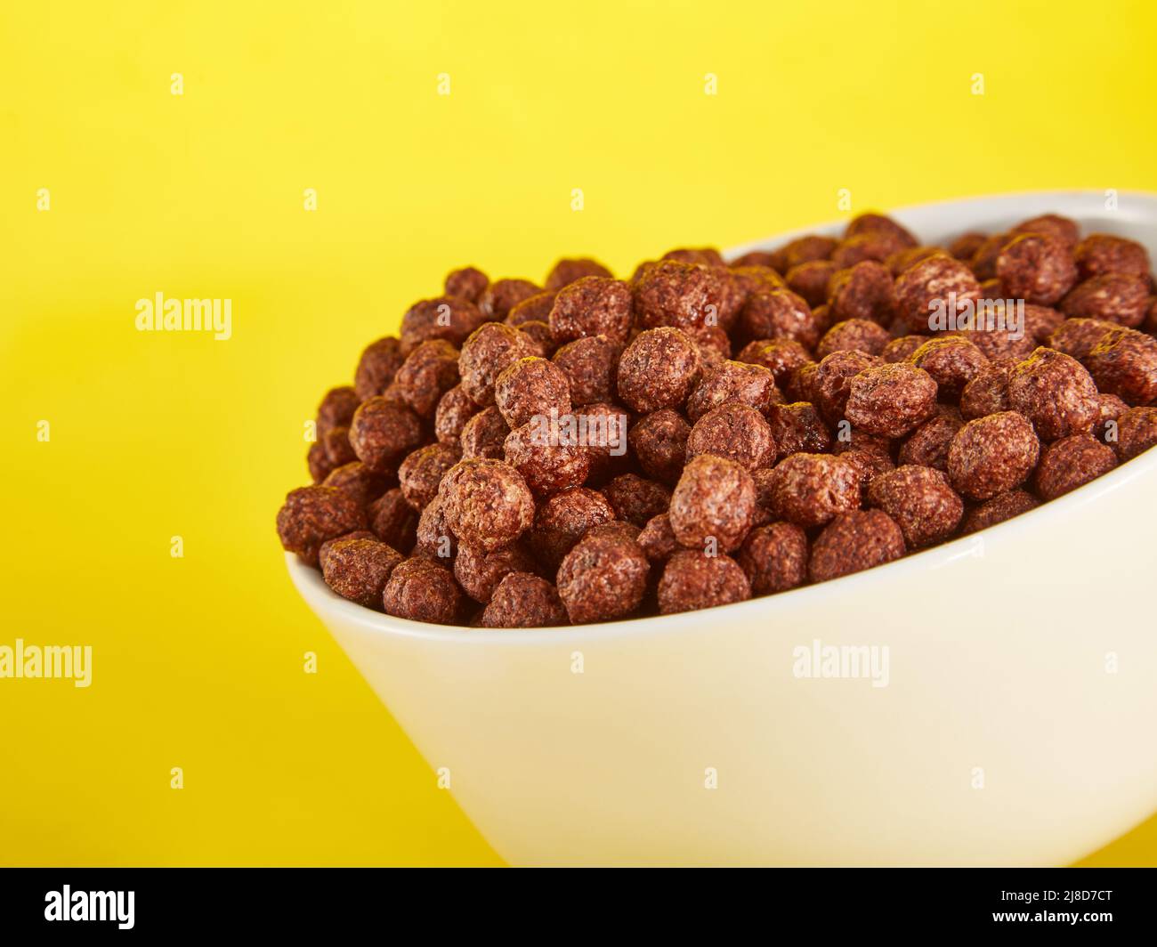 Chocolate Corn balls in bowl over yellow background Stock Photo - Alamy