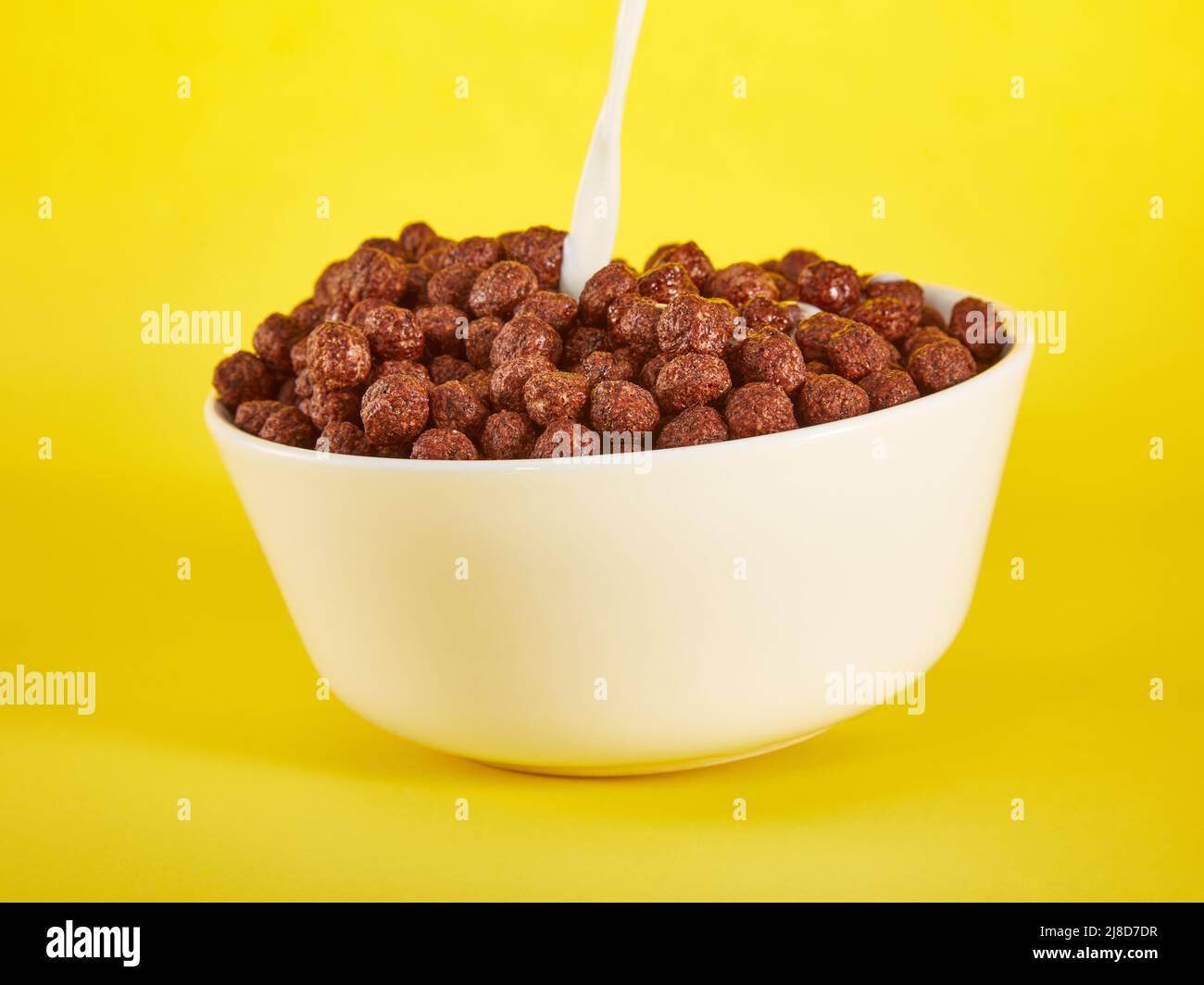 Chocolate Corn balls in bowl over yellow background Stock Photo - Alamy