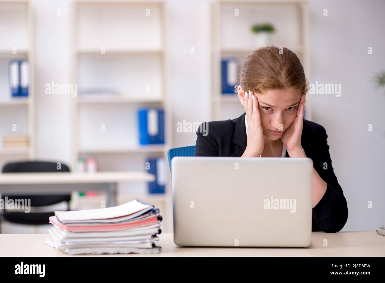 Female employee sitting at workplace Stock Photo - Alamy