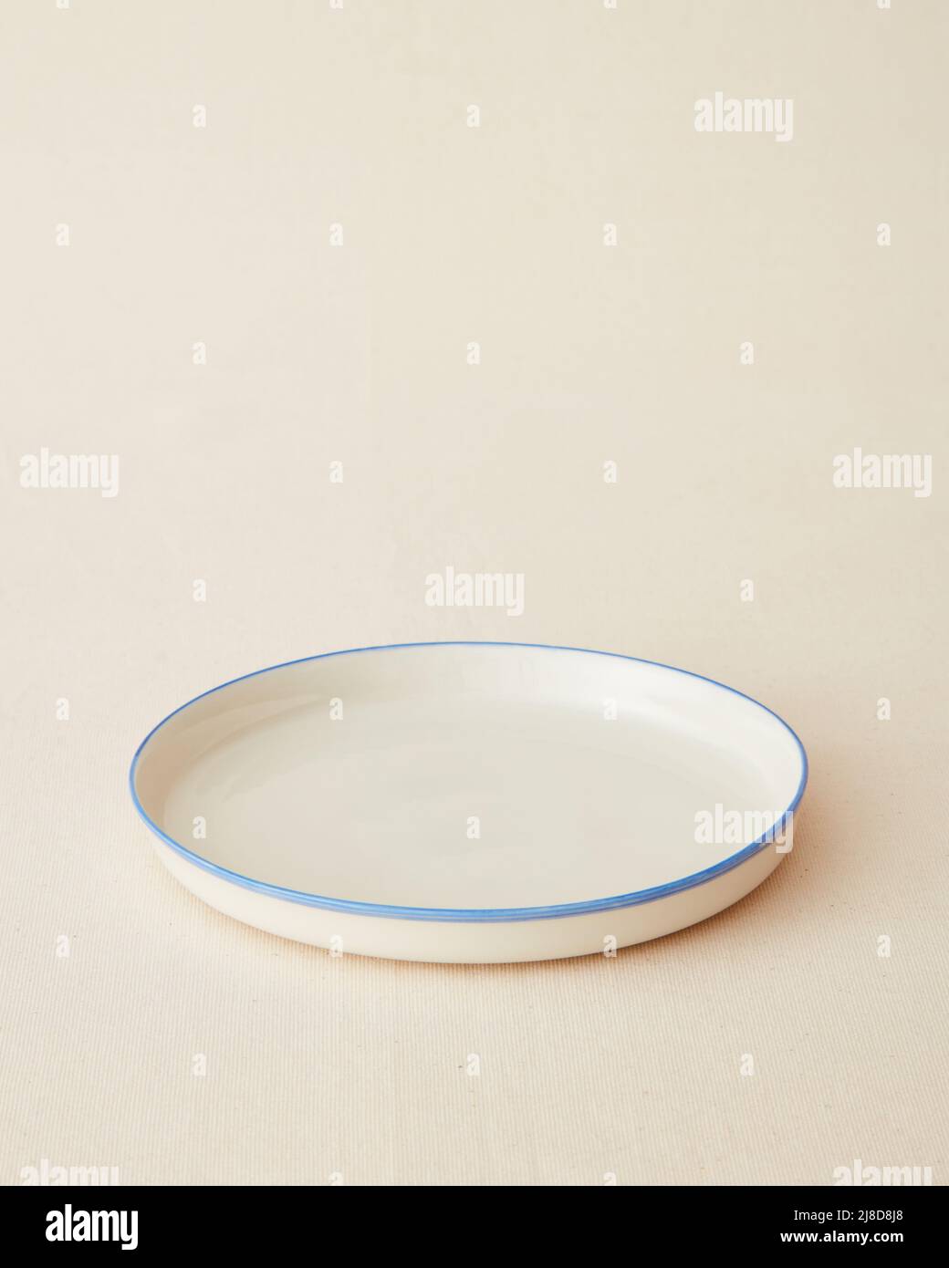 Handmade ceramic plate on beige background Stock Photo - Alamy