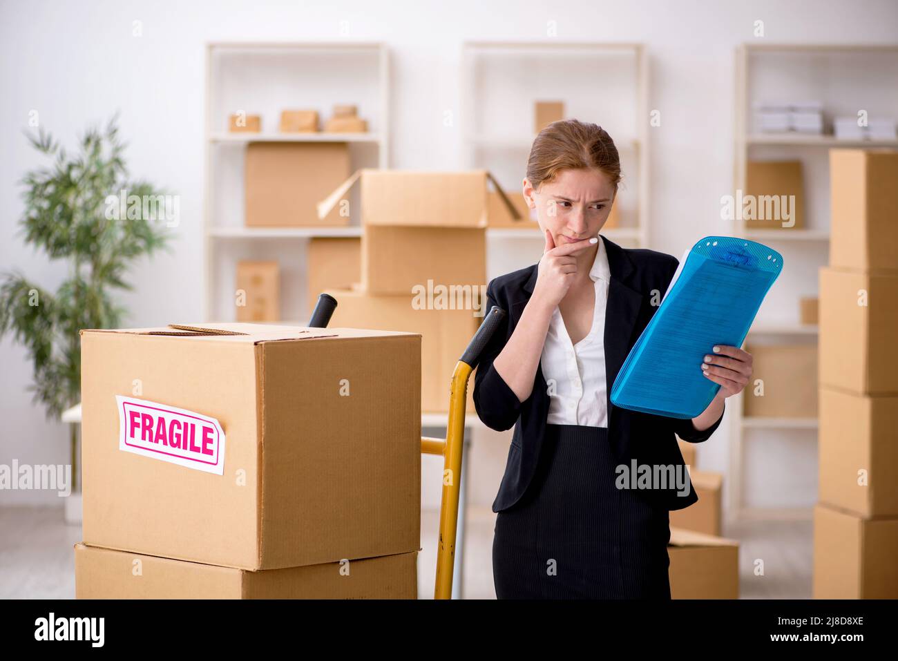Female professional mover doing home relocation Stock Photo - Alamy
