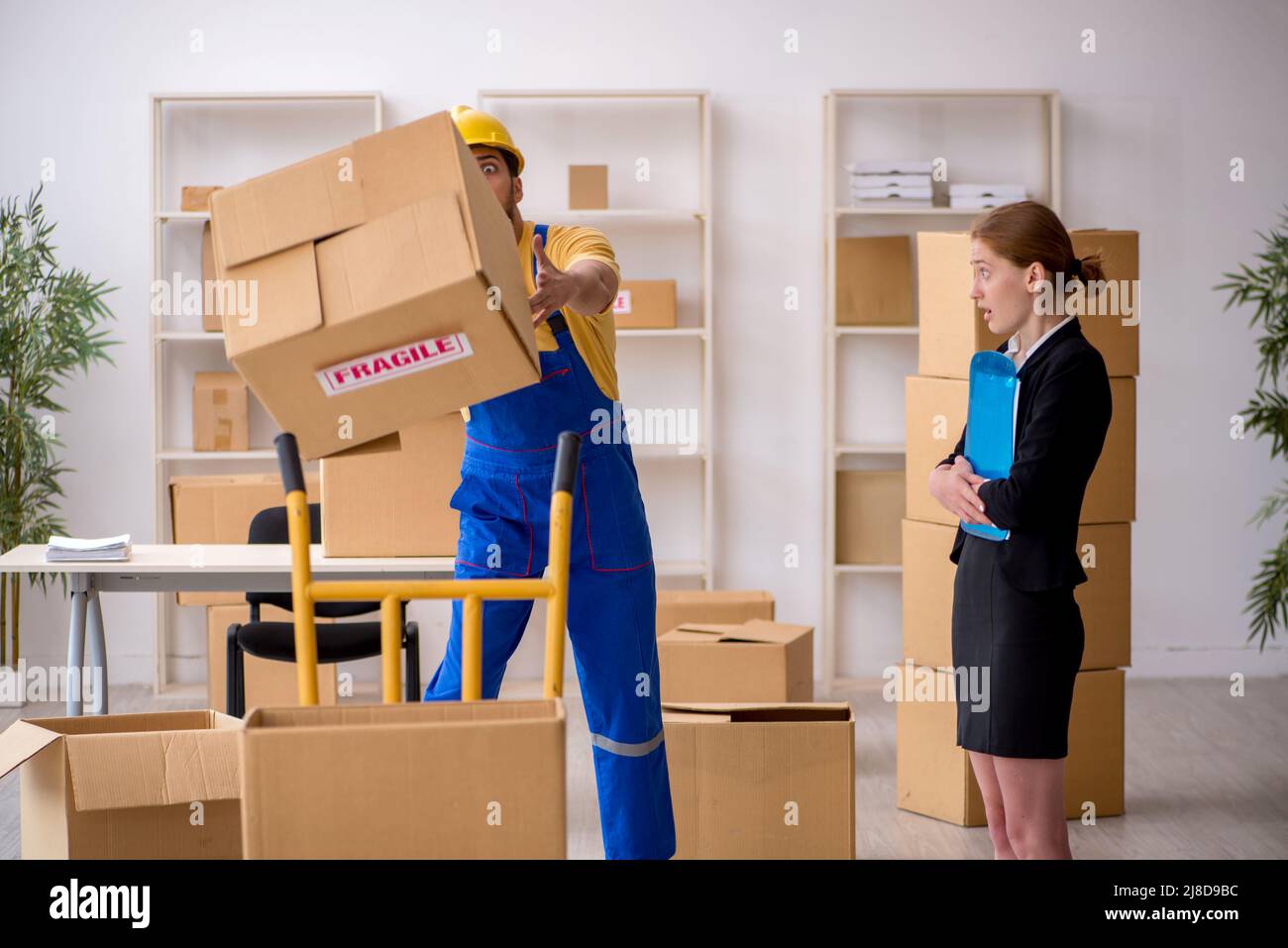 Female boss and male contractor doing home relocation Stock Photo - Alamy