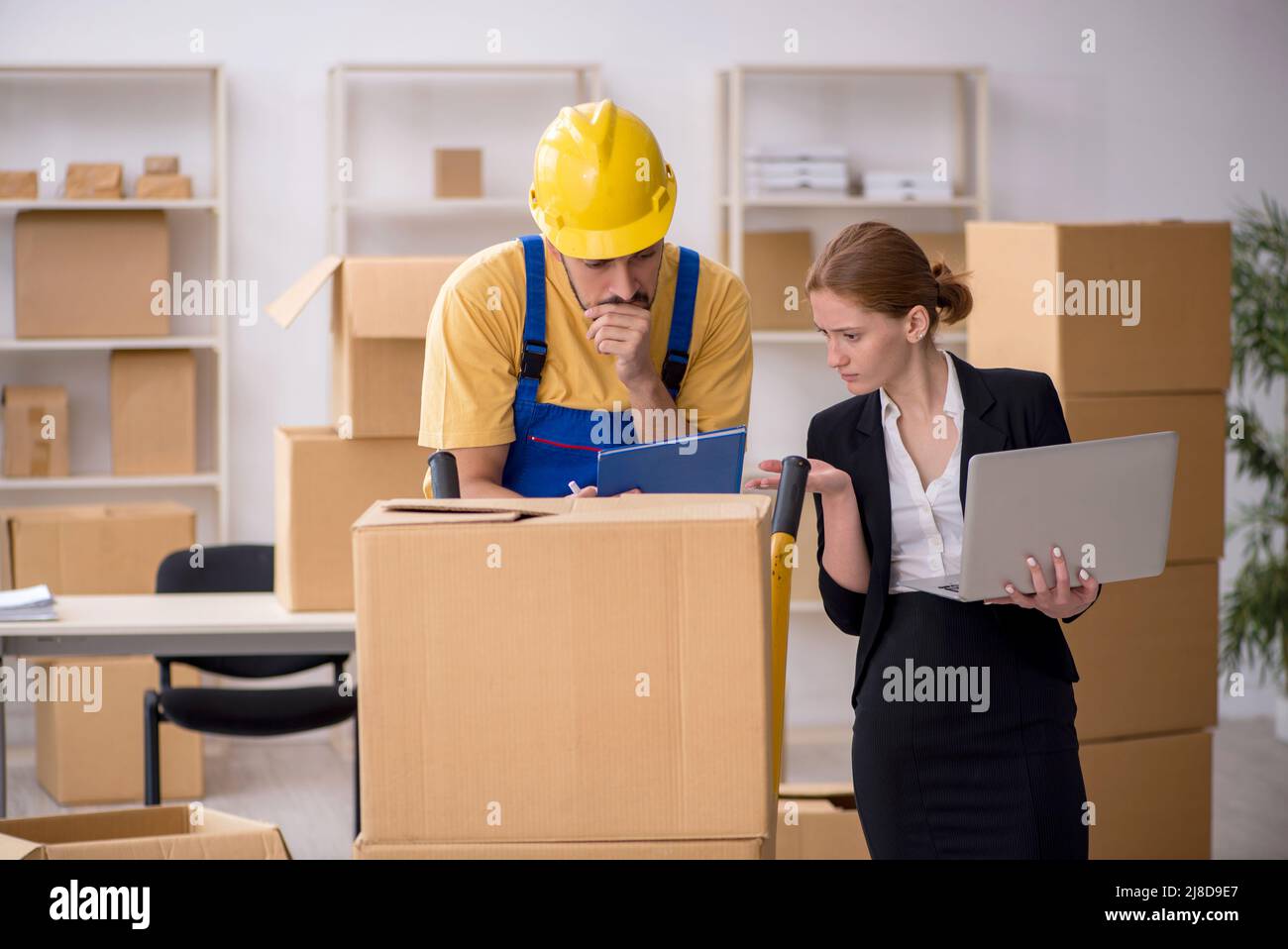 Female boss and male contractor doing home relocation Stock Photo - Alamy