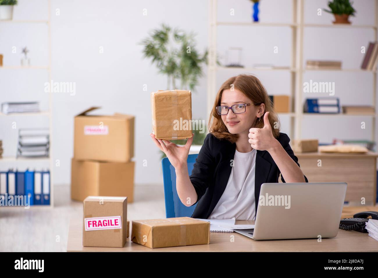 Office woman showing gift box hi-res stock photography and images - Alamy
