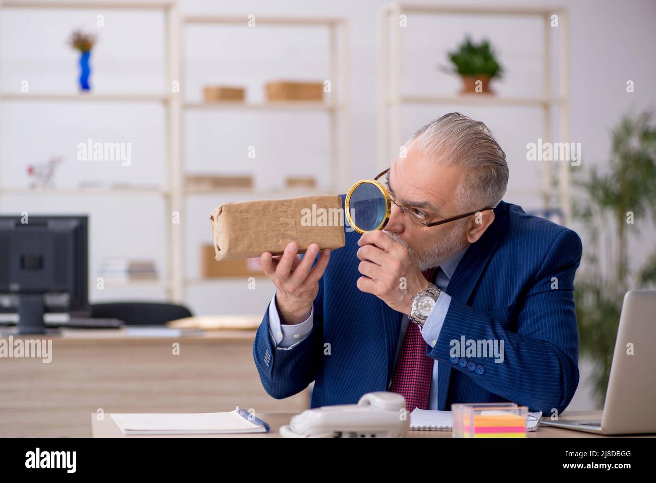 Old businessman employee ordering box via Internet Stock Photo - Alamy