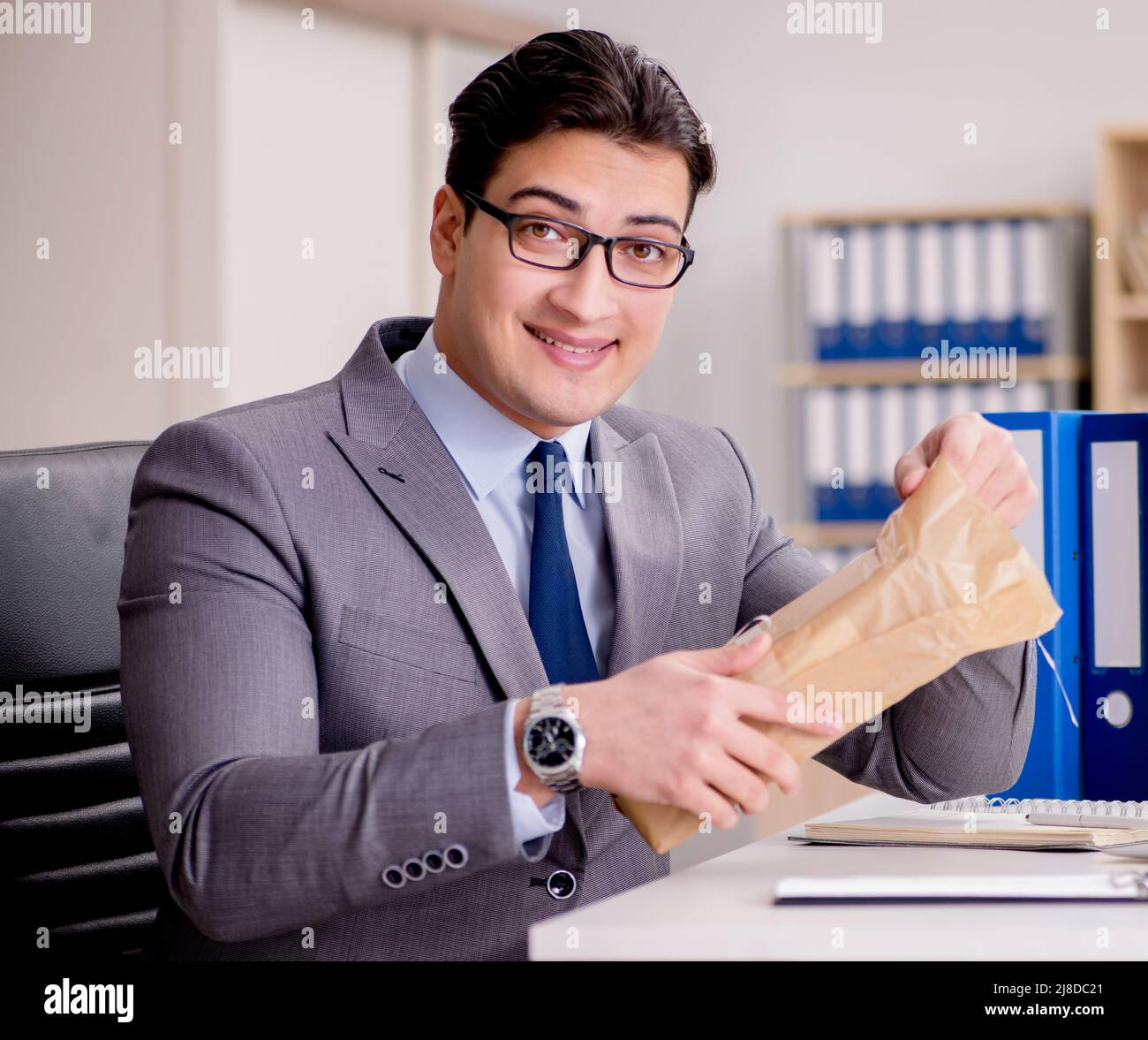 The businessman receiving parcel in office Stock Photo - Alamy