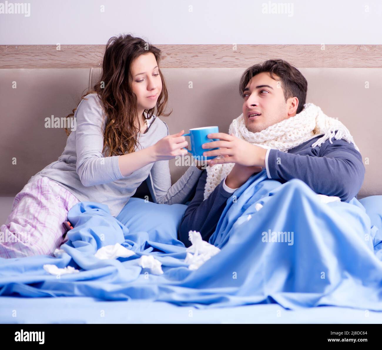 The wife caring for sick husband at home in bed Stock Photo - Alamy
