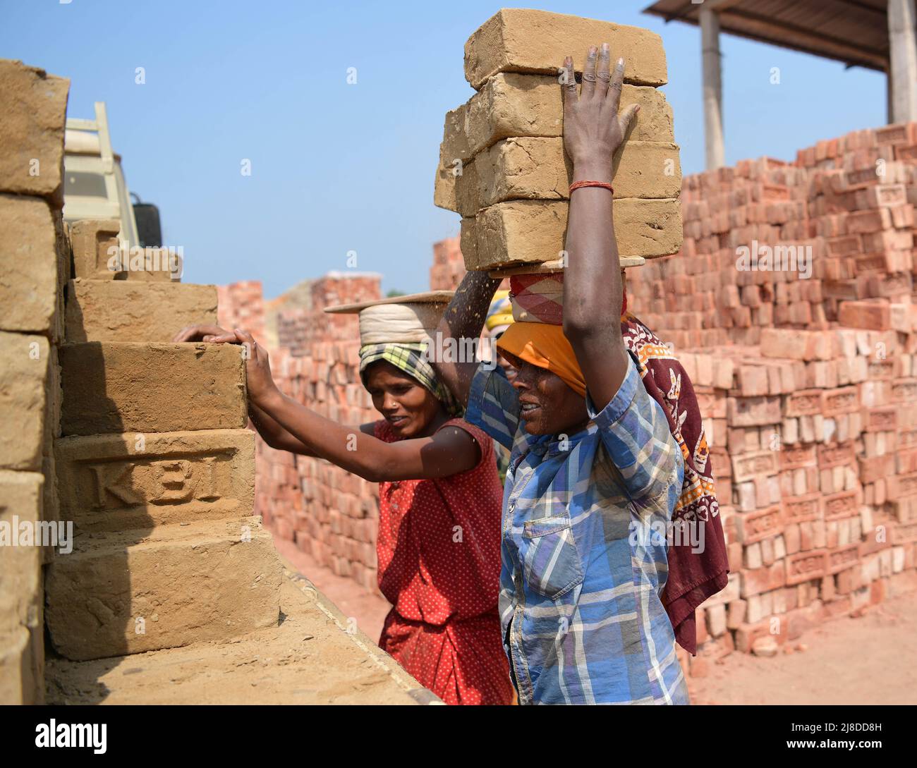 Labourers are working at a brick factory on May Day. May 1st is known ...