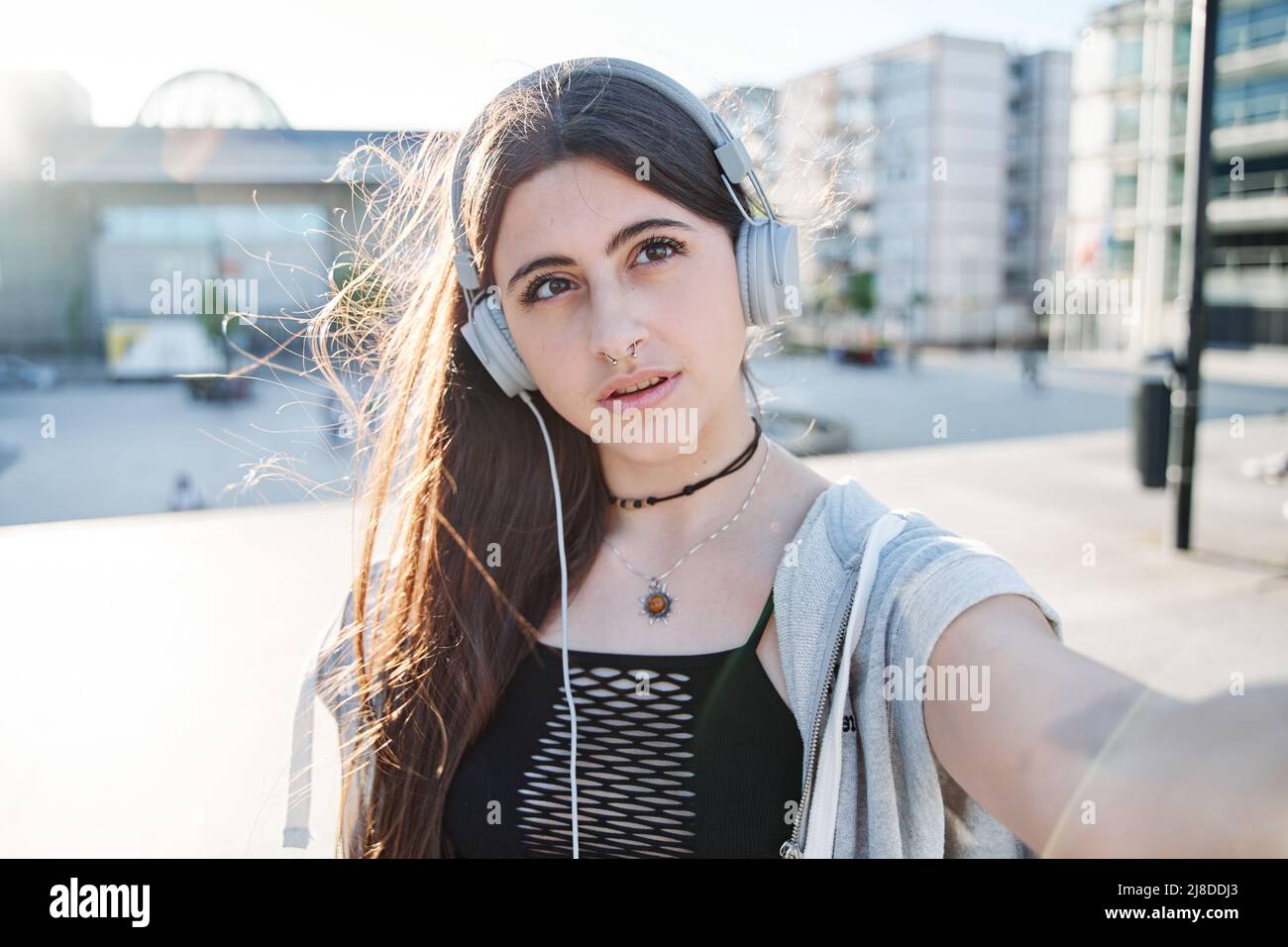 young teenager taking a selfie with a mobile phone. woman with ...