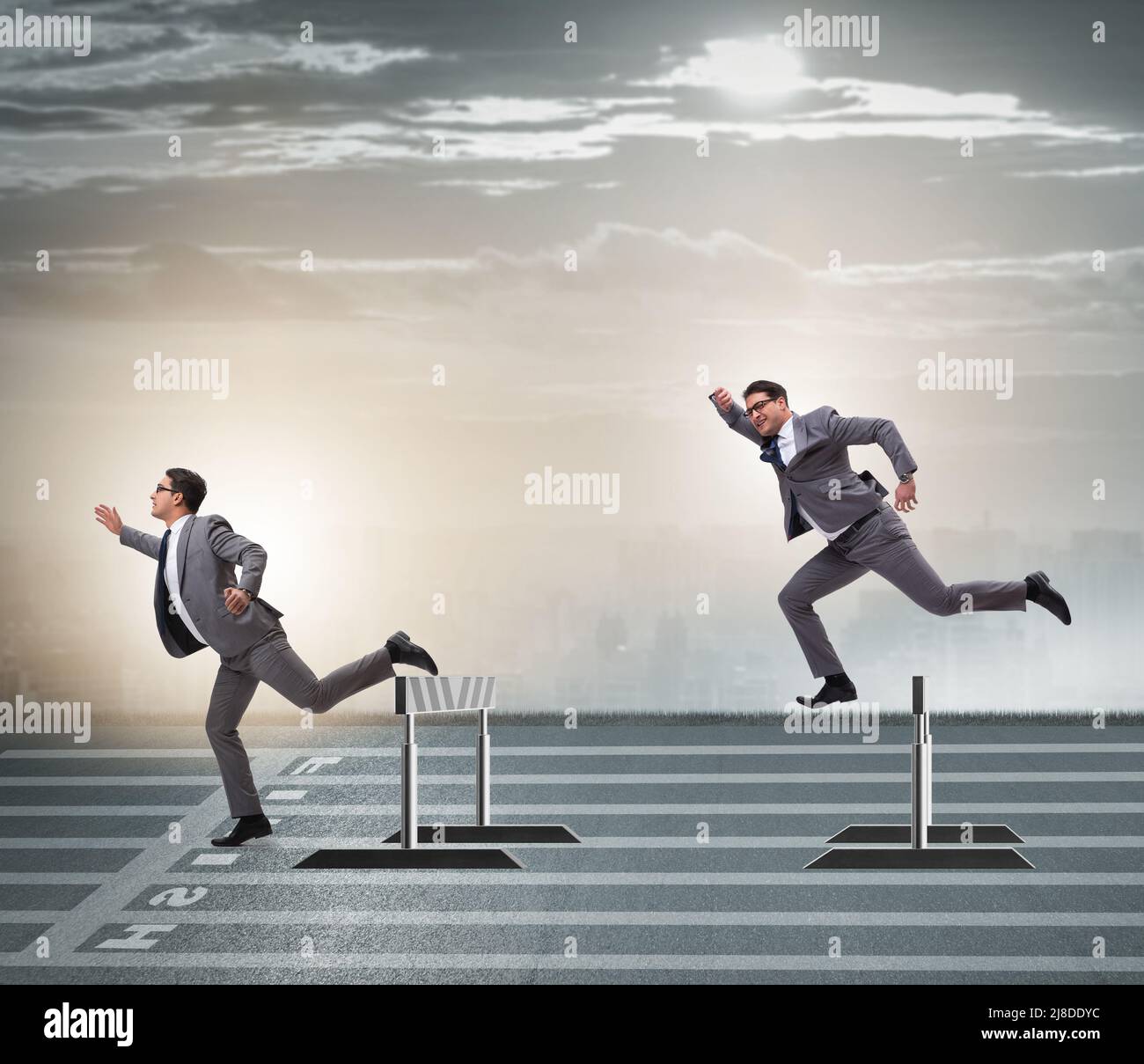 The businessman jumping over barriers in business concept Stock Photo ...