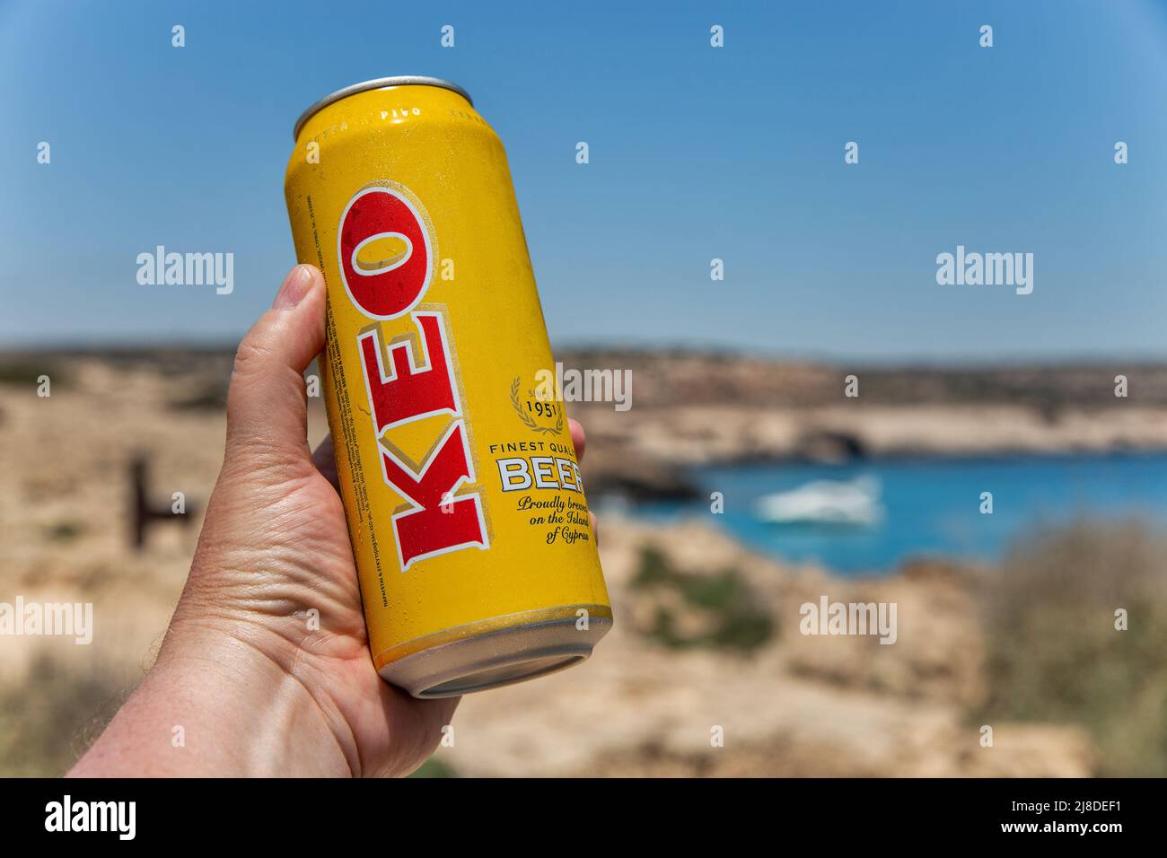 Ayia Napa, Cyprus - May 27, 2021: White man's hand holds a can of KEO ...