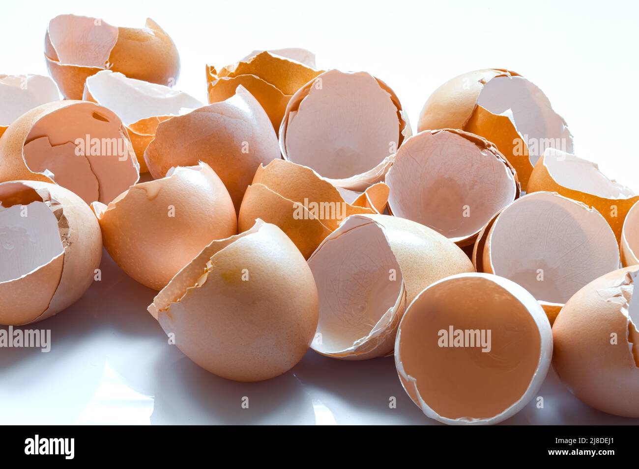 a pile of broken brown egg shells close-up, empty eggs without protein ...