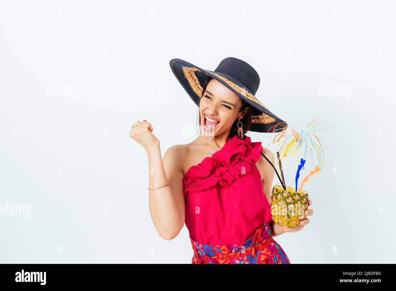 Fashionable happy young woman wearing summer outfit and hat holding ...