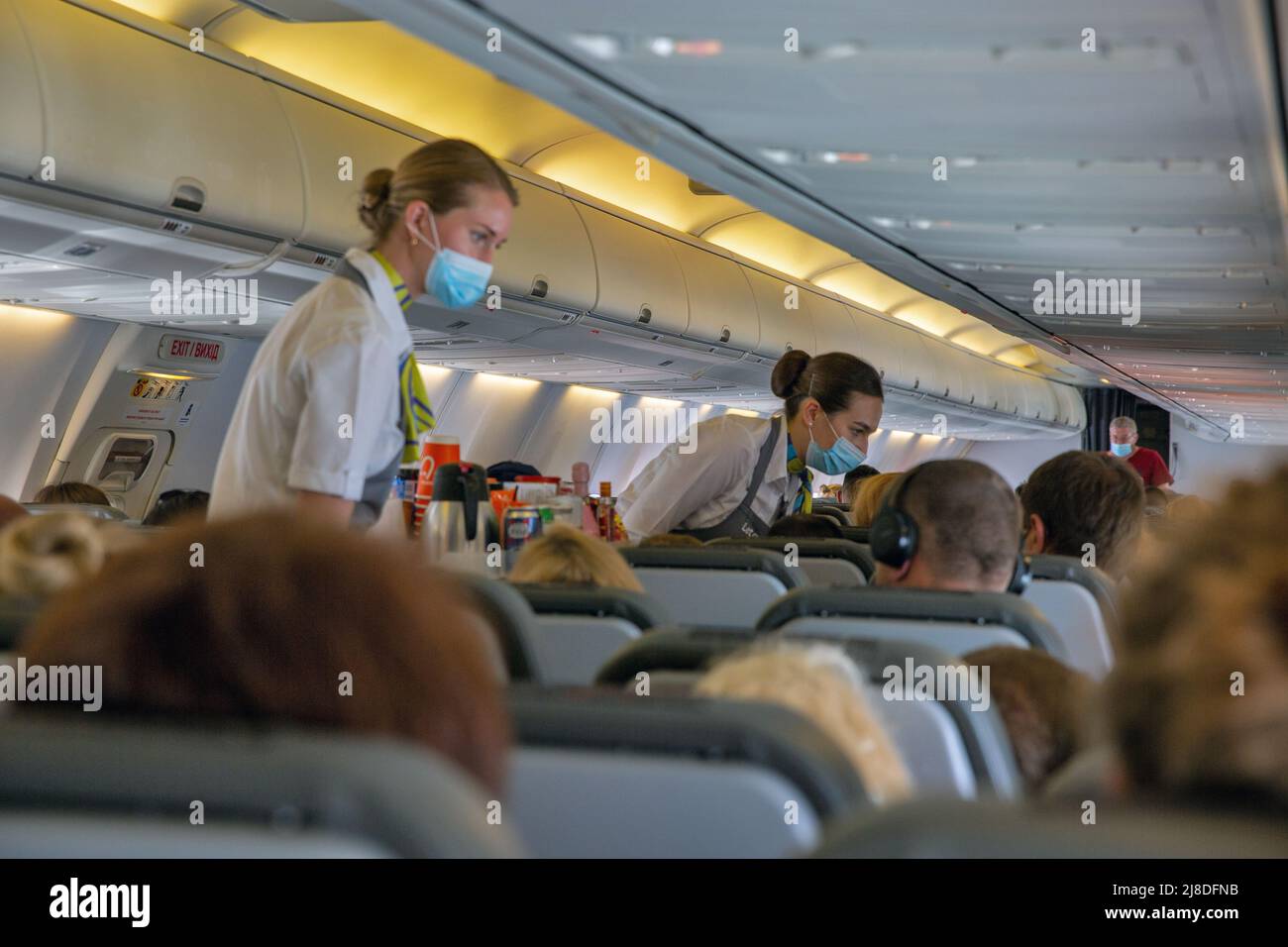 Larnaca, Cyprus - May 31, 2021: Stewardess offers refreshment cold and ...