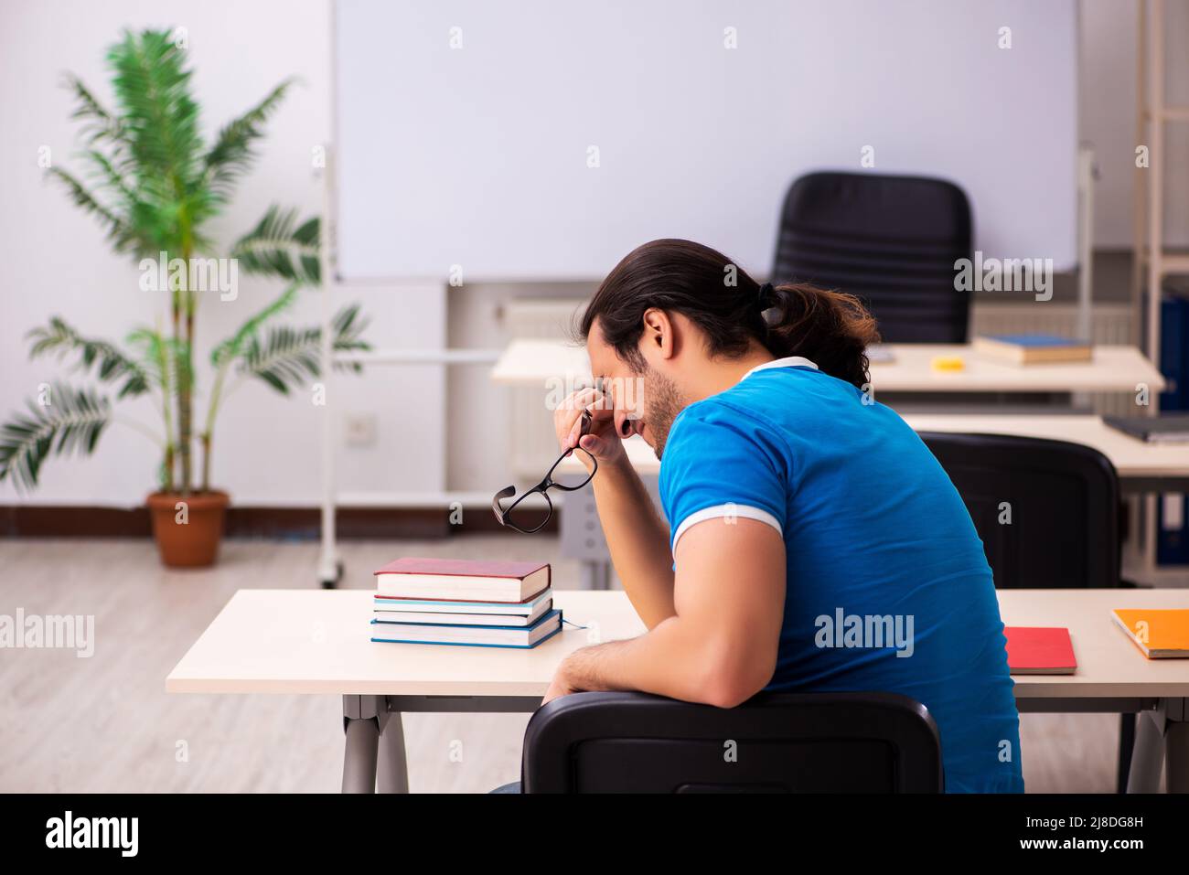 Young student in the classroom Stock Photo - Alamy