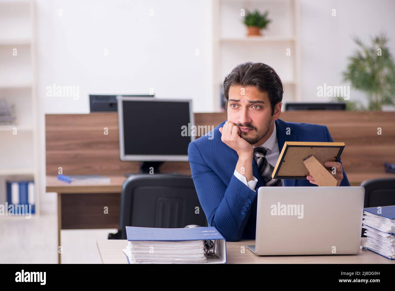 Young employee missing girlfriend at workplace Stock Photo - Alamy