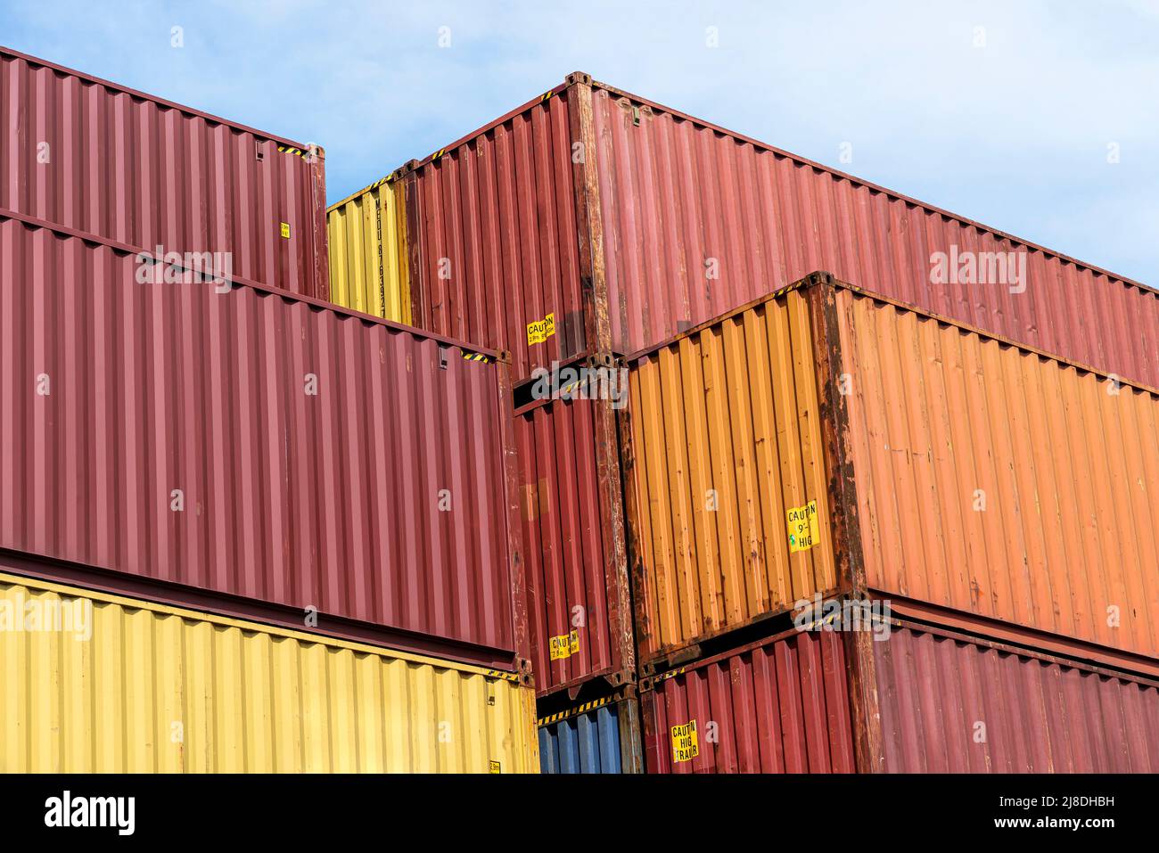 A stack of containers standing on top of each other in the loading yard ...