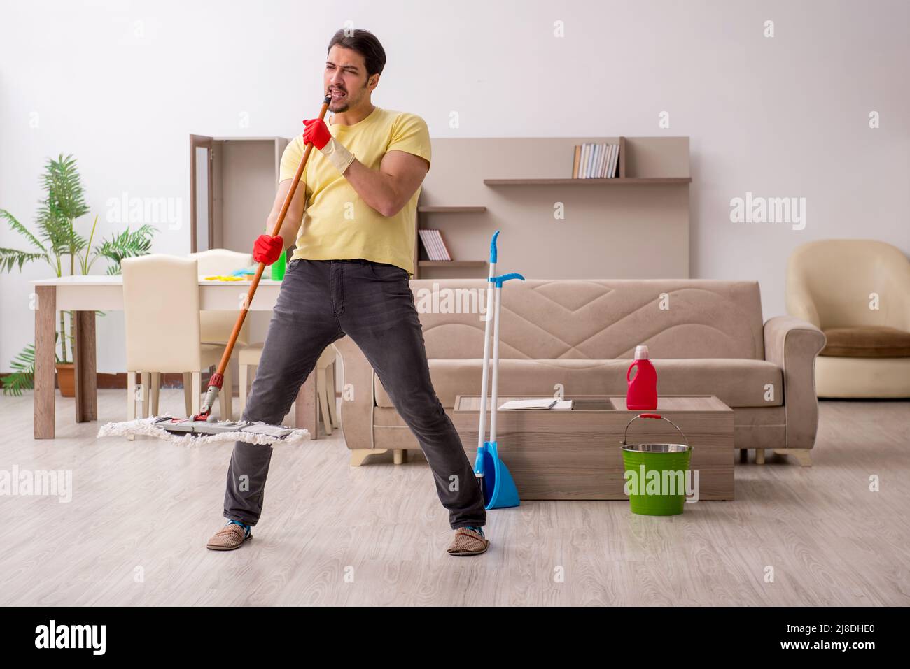 Young male cleaner cleaning the house Stock Photo - Alamy