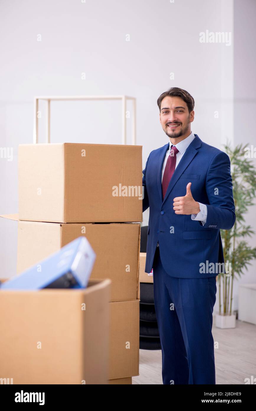 Young employee in relocation concept Stock Photo - Alamy