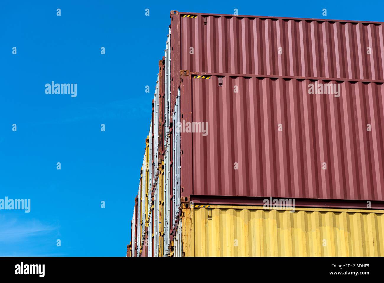 A stack of containers standing on top of each other in the loading yard ...