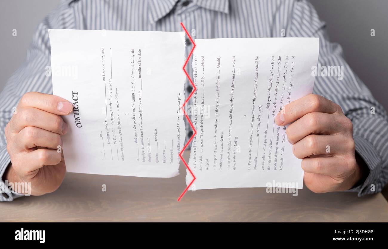 Torn document in man hands. Contract cancellation or dismissal concept ...