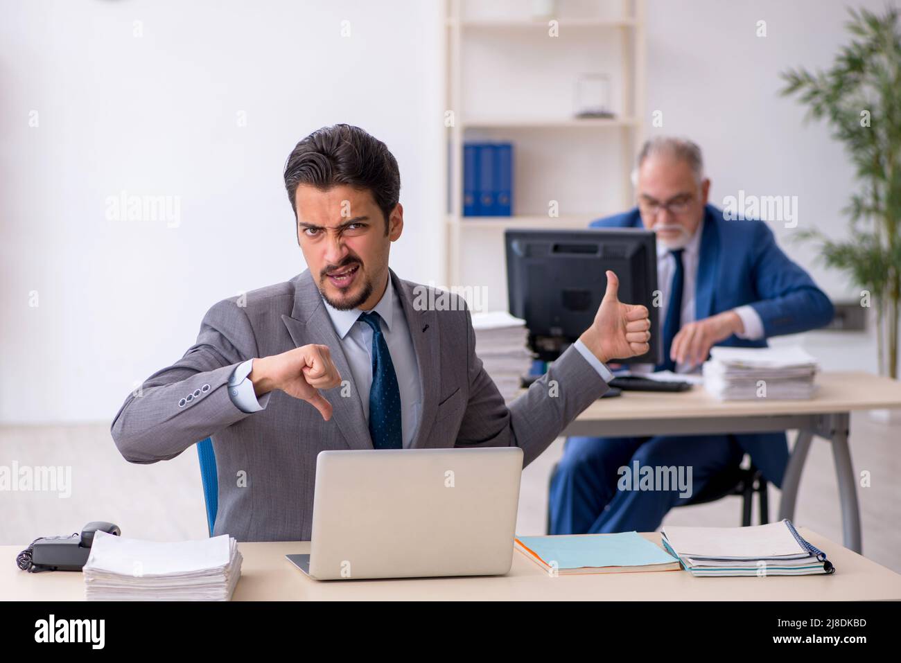 Two male employees working in the office Stock Photo - Alamy